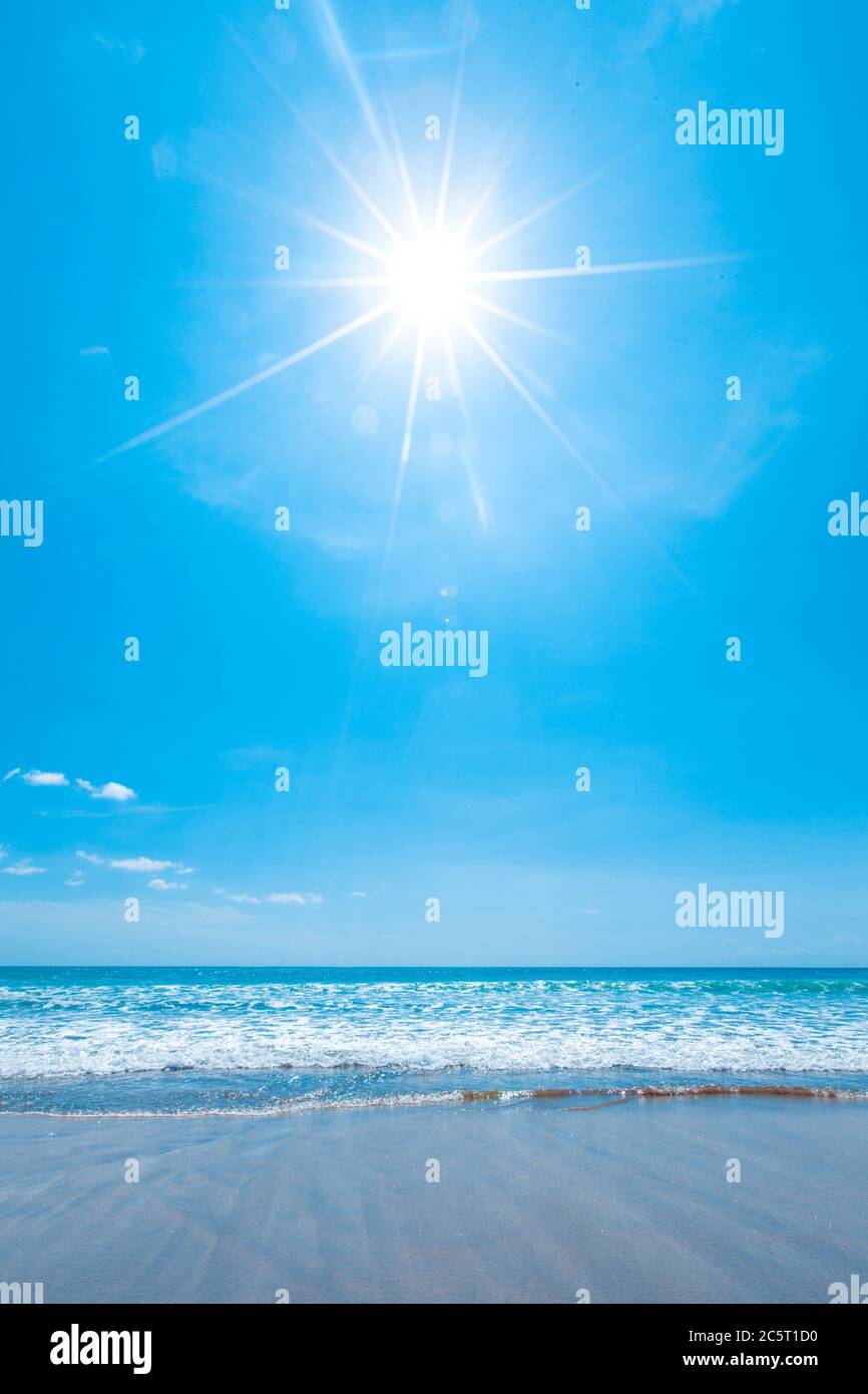 Sun shining bright over beautiful sea beach vertical shot Stock Photo ...