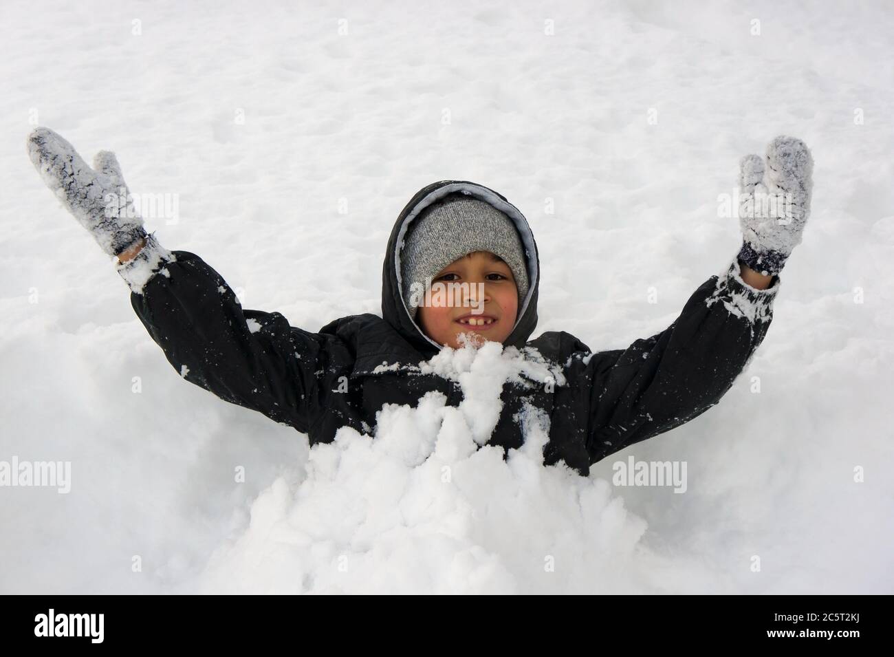 Funny boy playing in snow, outdoors in winter Stock Photo - Alamy