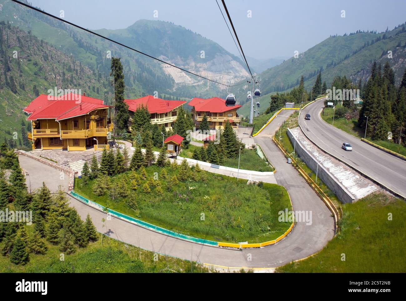 Cable car and car-way through Alps mountains in the summer Stock Photo ...