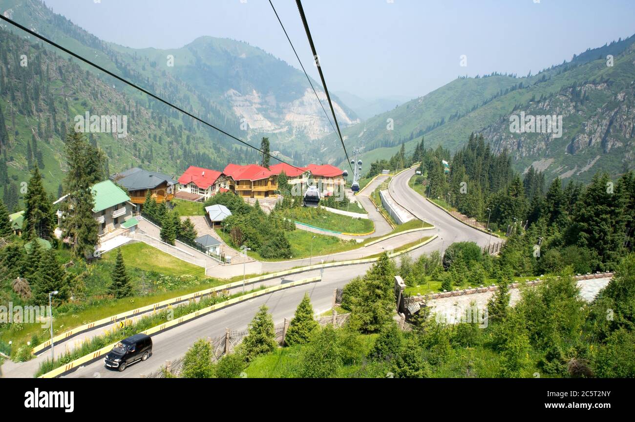 Cable car and car-way through Alps mountains in the summer Stock Photo ...