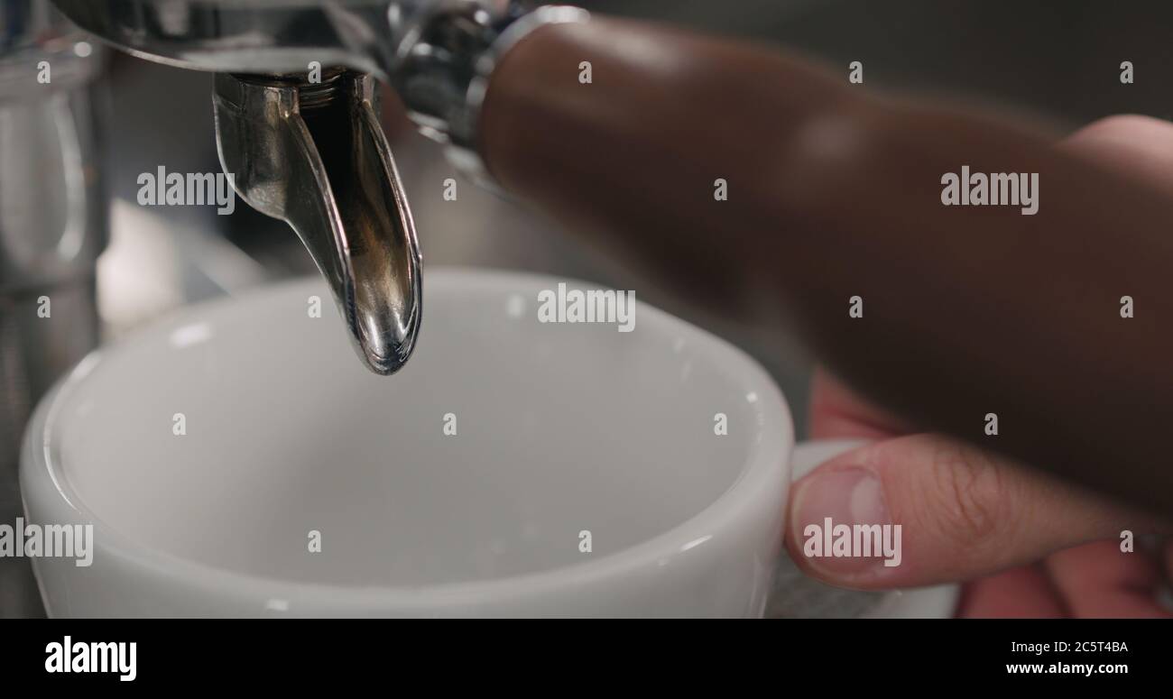 pulling espresso shot with single spout portafilter from coffee machine ...