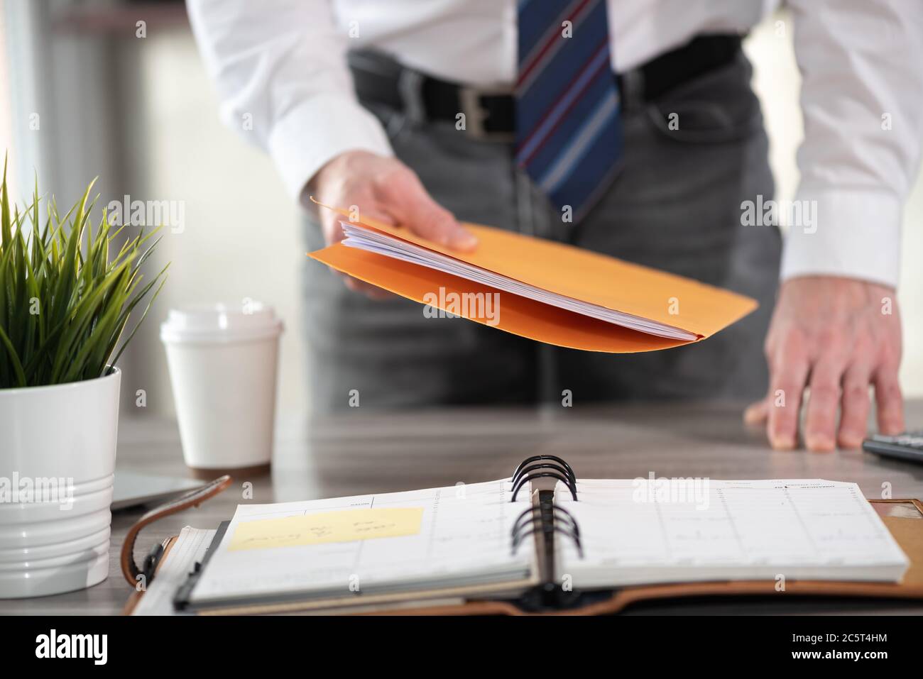 Businessman holding folder with paper documents Stock Photo - Alamy
