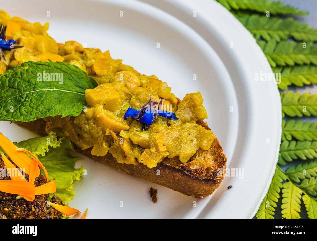 appetizer of calendula flowers and crouton. Plate decorated with fresh ...