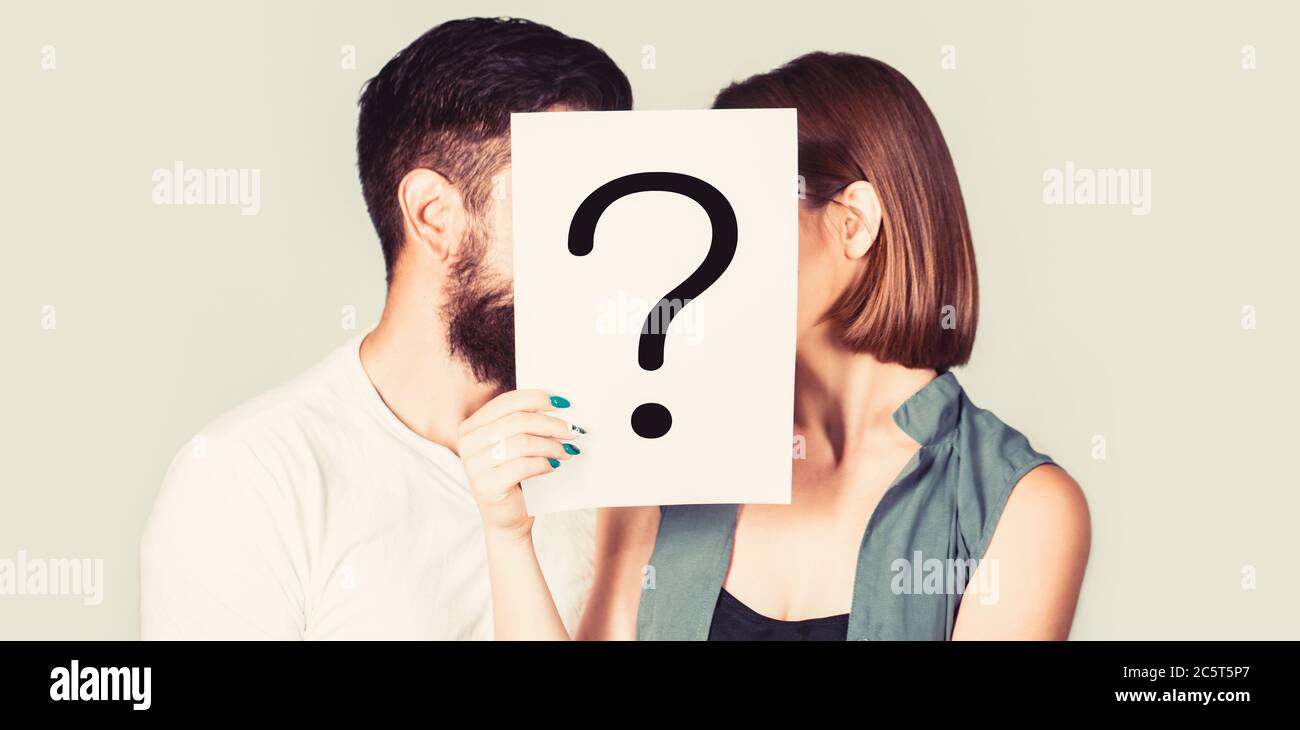 Couple holding paper question mark. Anonymous, man and woman question ...