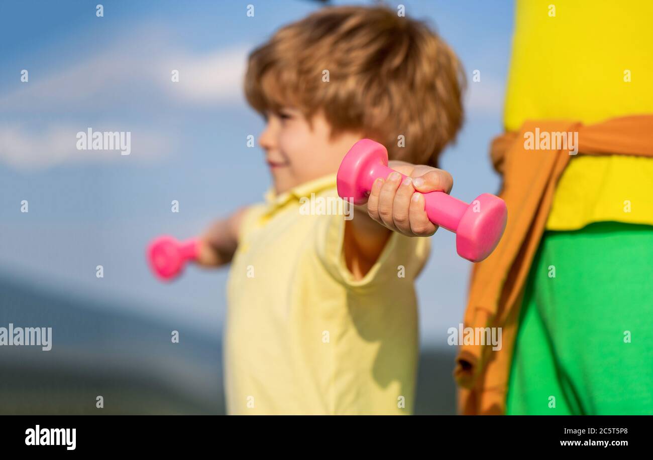 Sporty boy with dumbbells. Sport. Fitness, health and energy. Cheerful ...