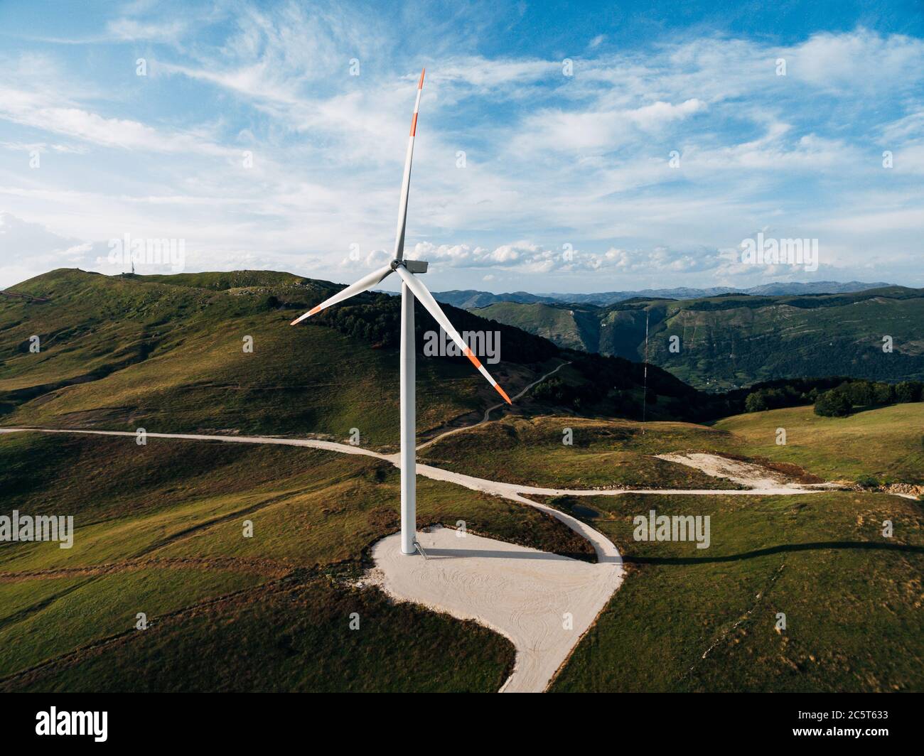 Beautiful bright photo of the wind generator in the field with the road ...