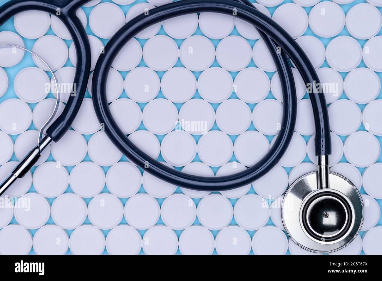 Medical statoscope on a background of white pills. Concept of health ...