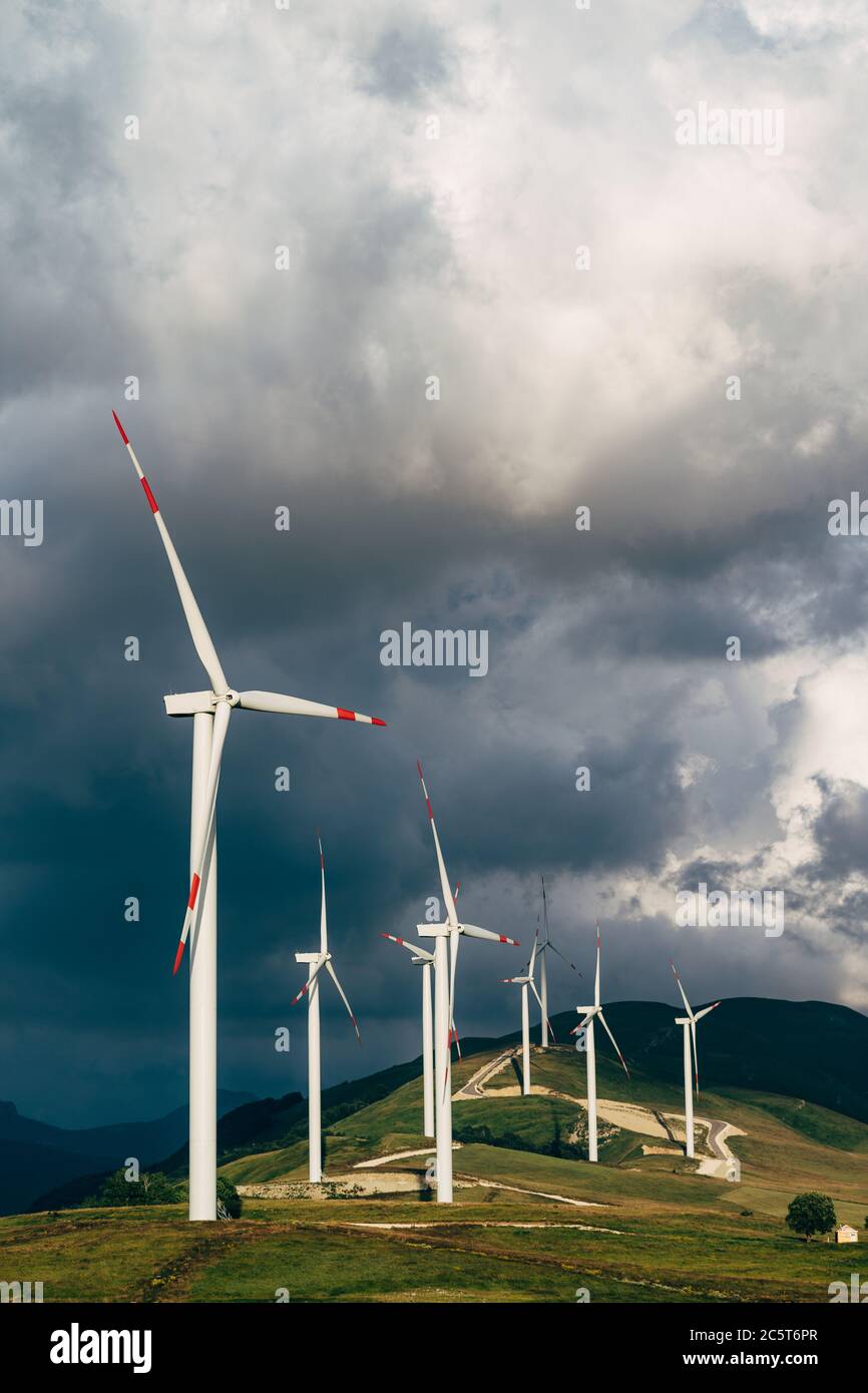 Huge wind turbines on the hill next to the apartment building Stock ...