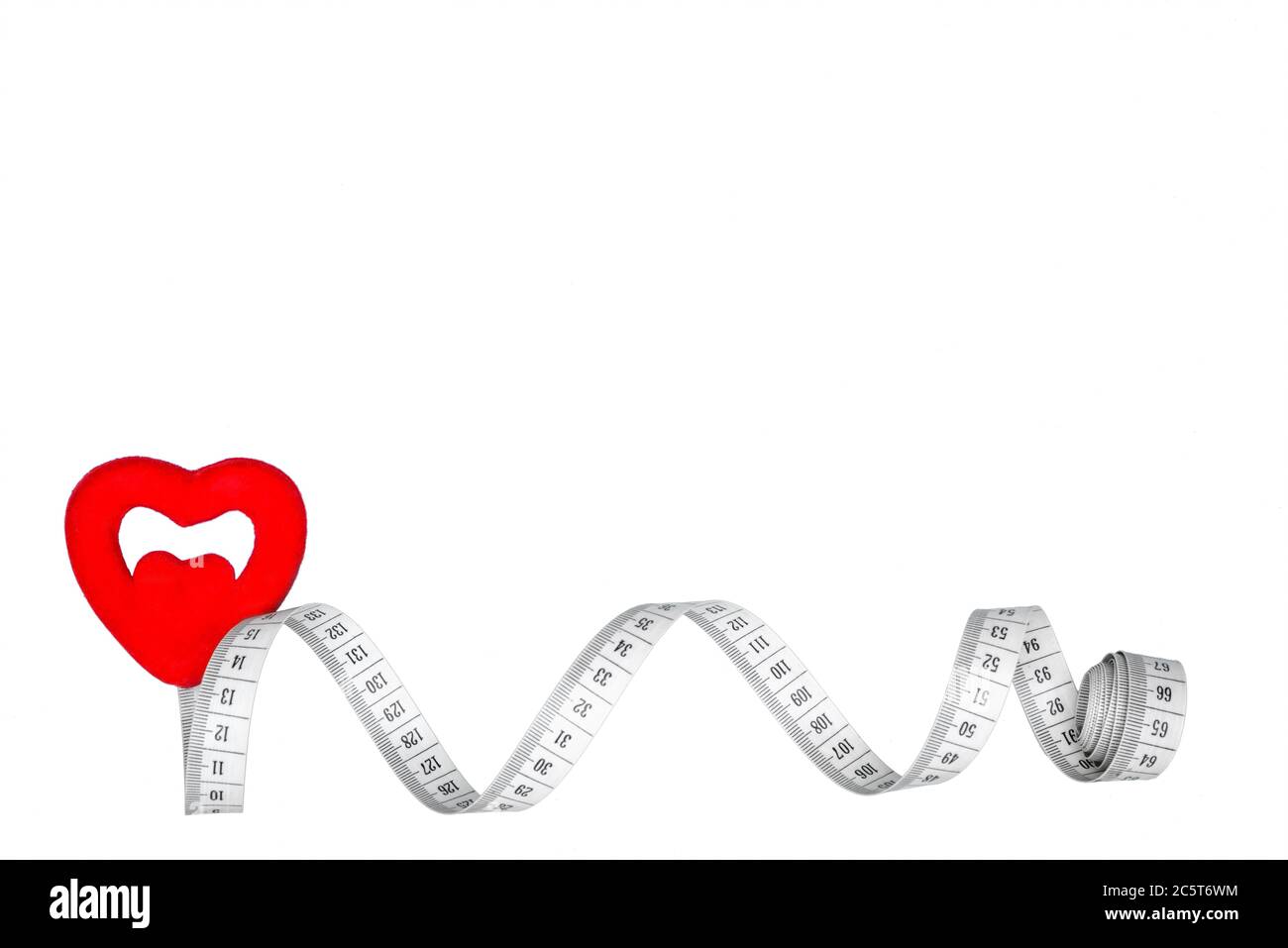 Concept of healthy lifestyle. Flexible meter and red heart closeup ...