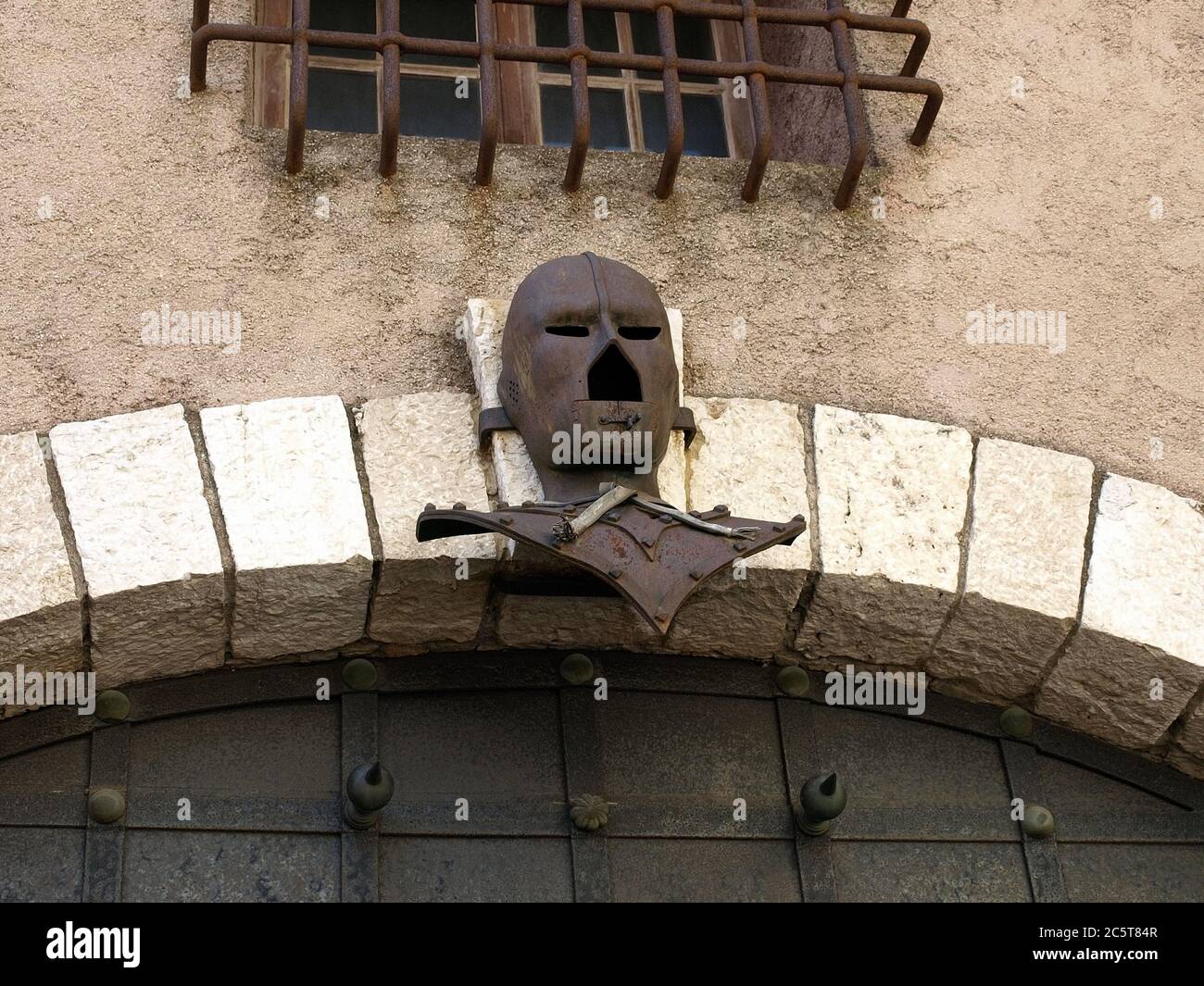 Ancient metal gate with helmet of medieval knight. La Tour Du Suquet in ...