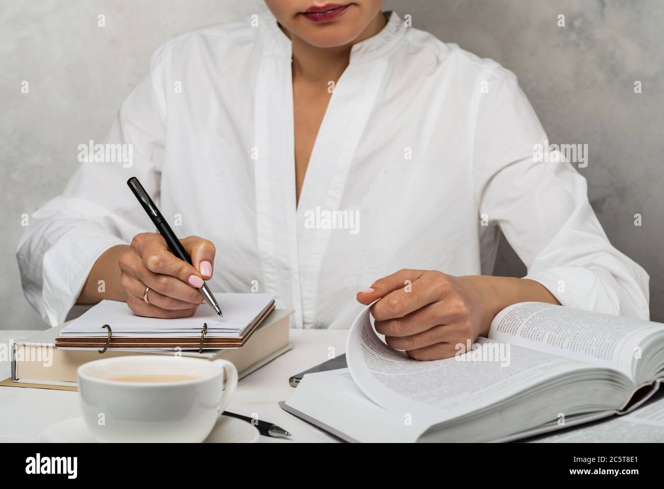 Student study at home. Girl write and read book Stock Photo - Alamy