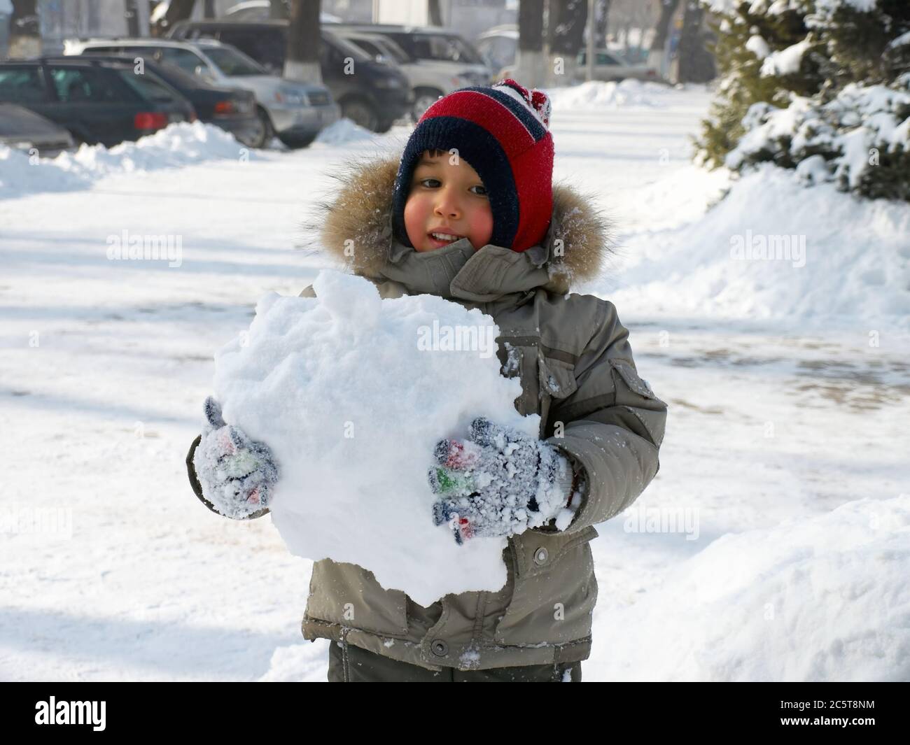 Little boy holding big snowball, outdoors in winter Stock Photo - Alamy