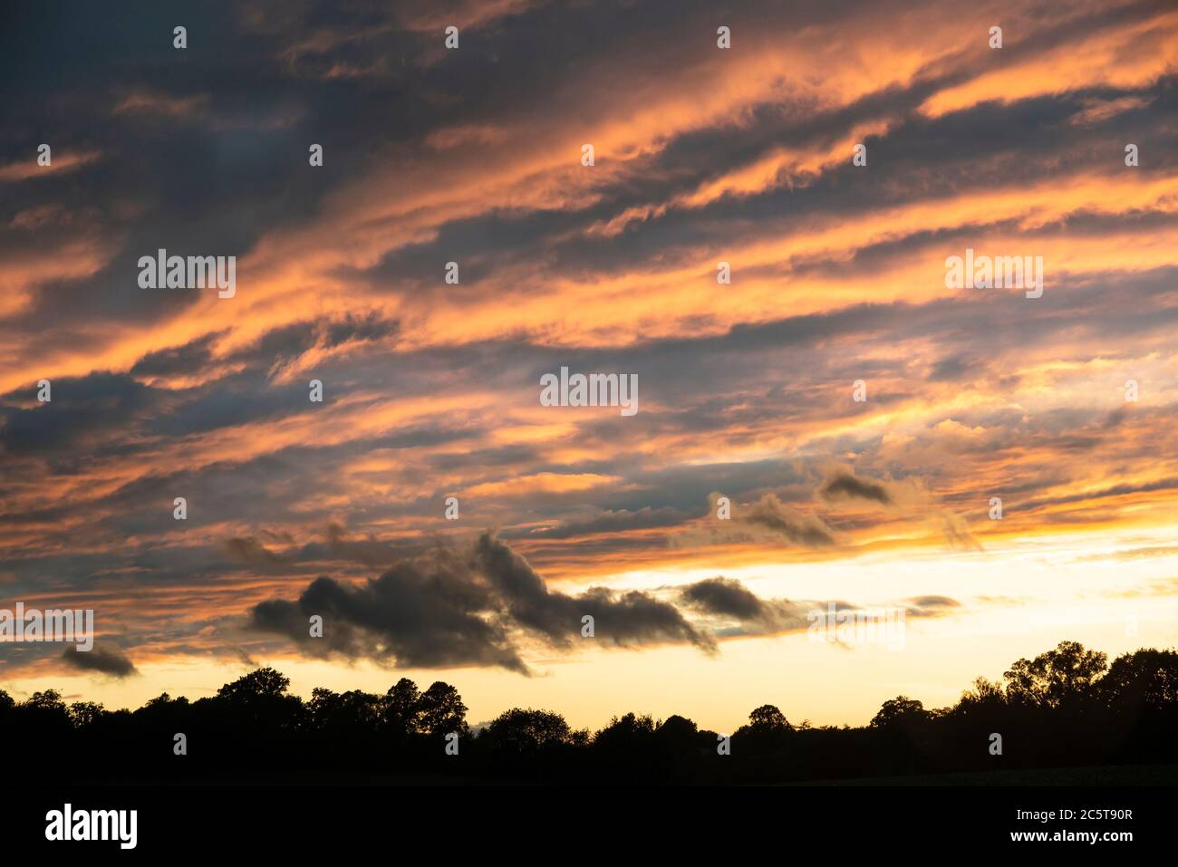 Beautiful Summer sunset sky with colorful vibrant clouds and sun beams ...