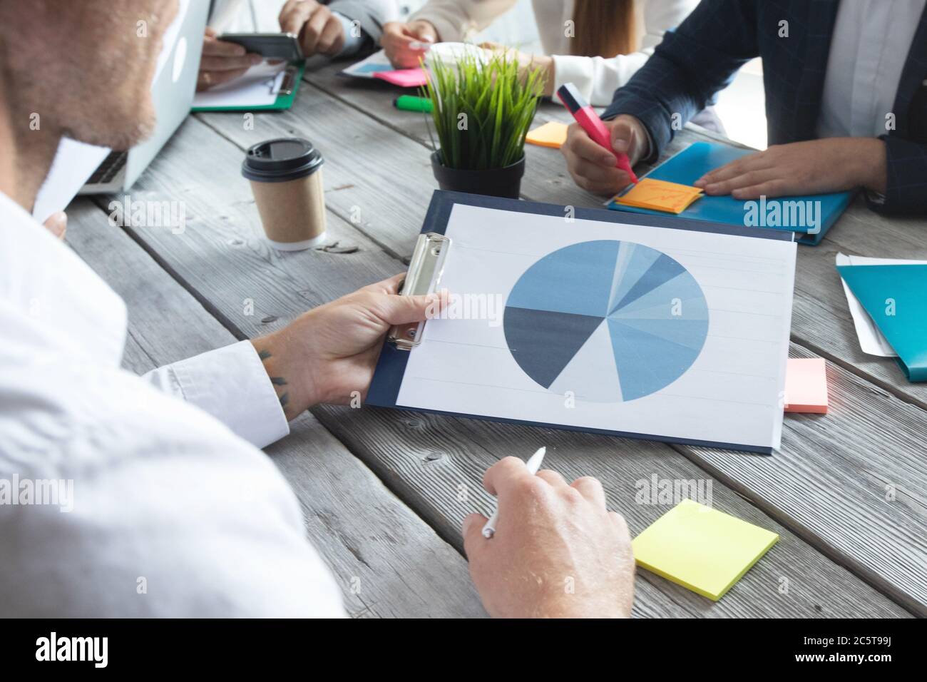Business people analyzing data diagrams financial reports development ...