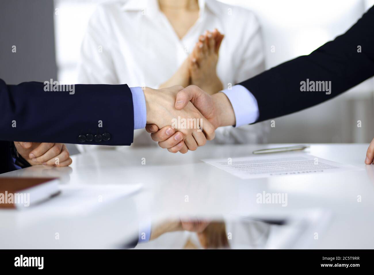Business people shaking hands at meeting or negotiation, close-up ...