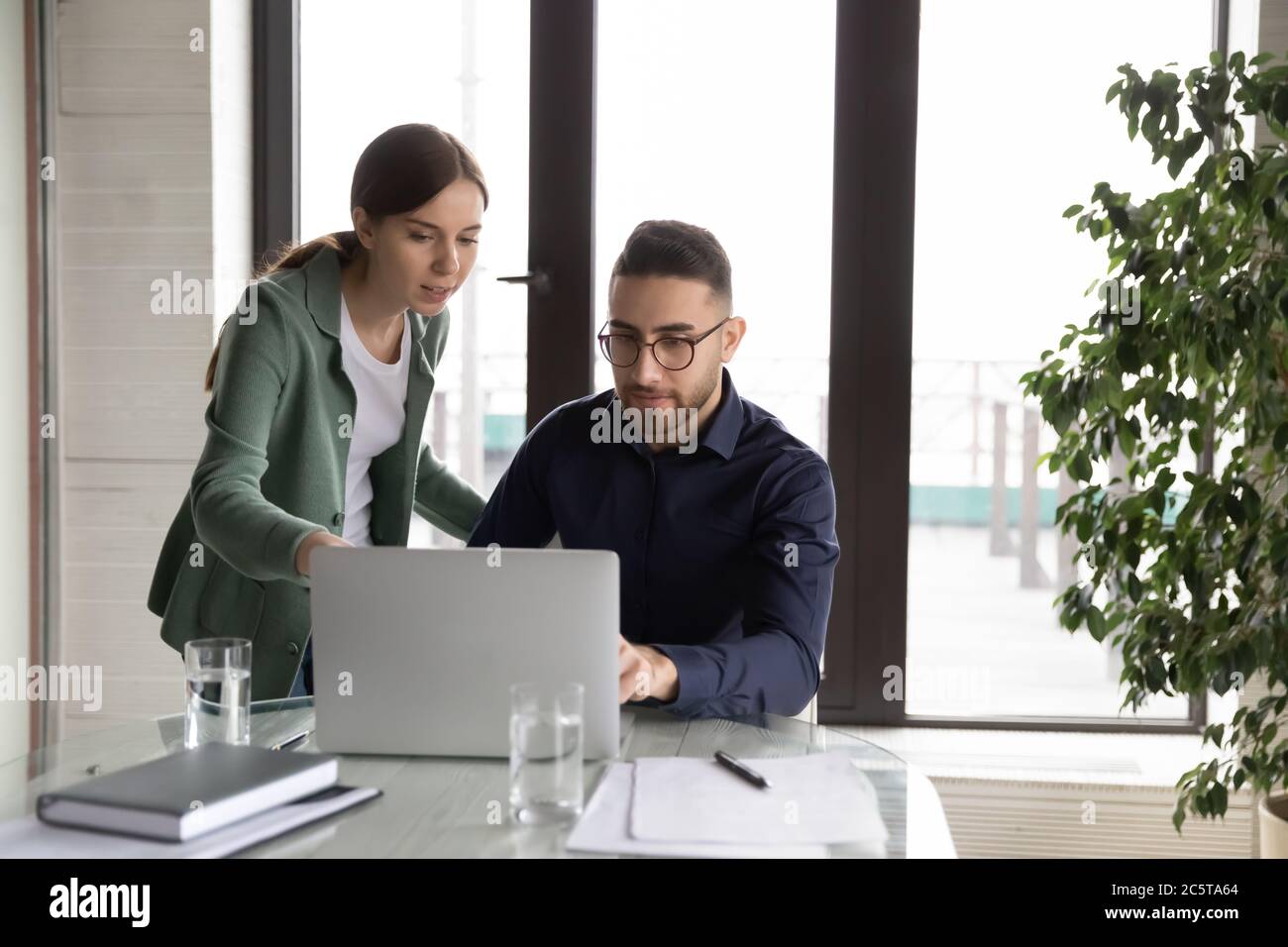 Multiethnic colleagues work together on laptop in office Stock Photo ...