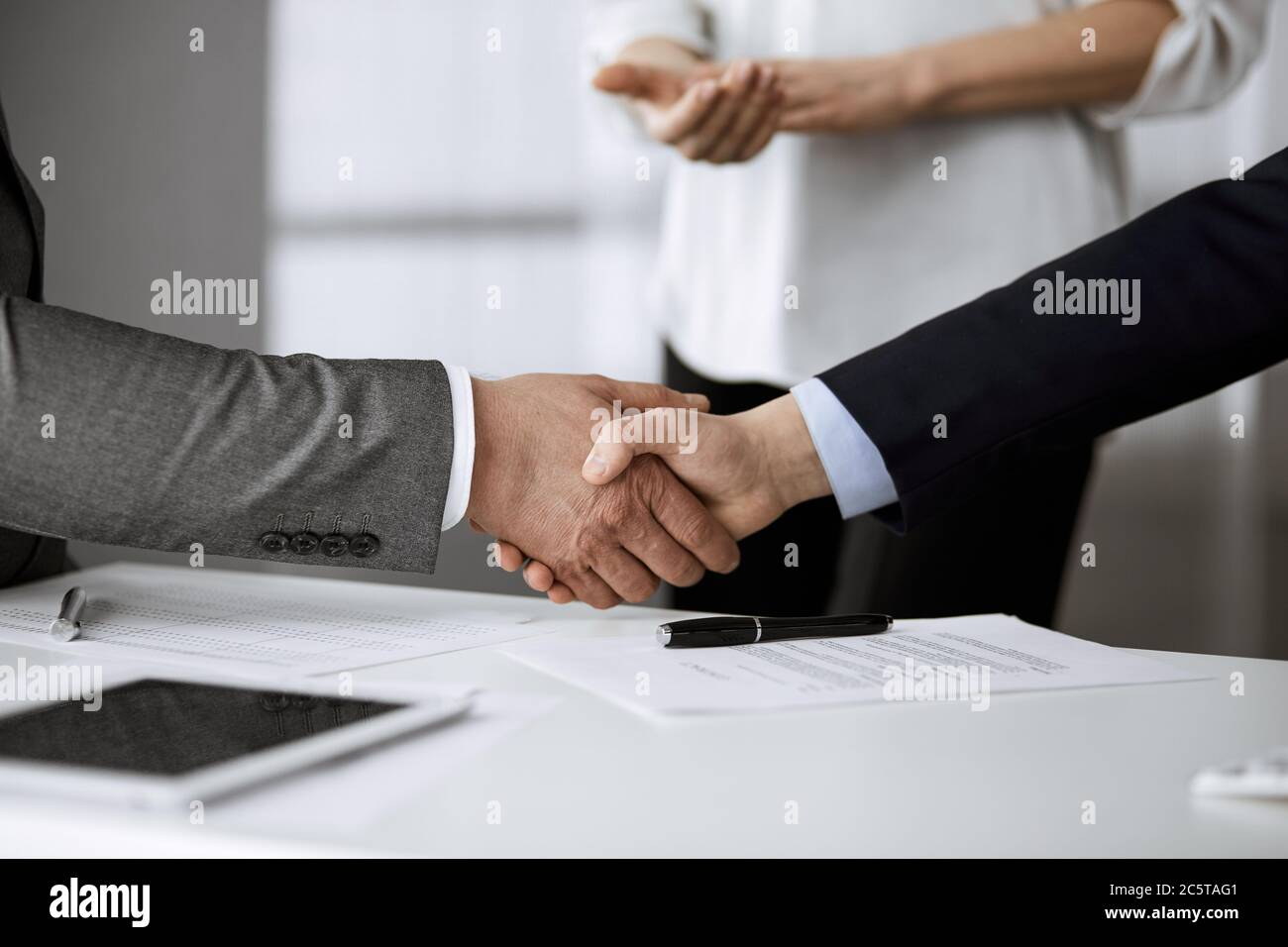 Business people shaking hands finishing contract signing, close-up ...