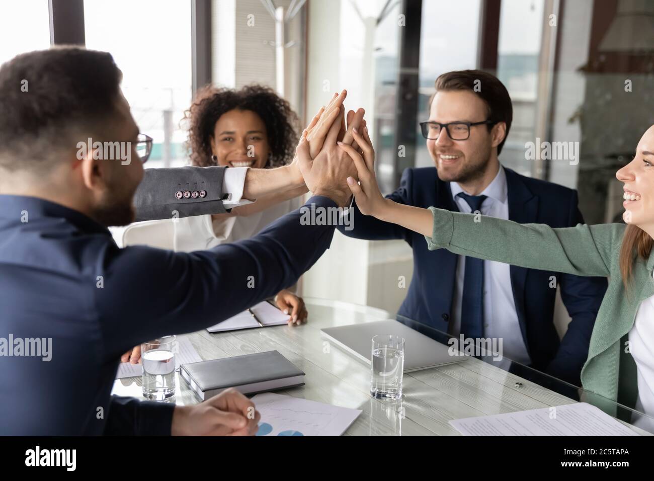 Diverse employees business team give hi-res stock photography and ...