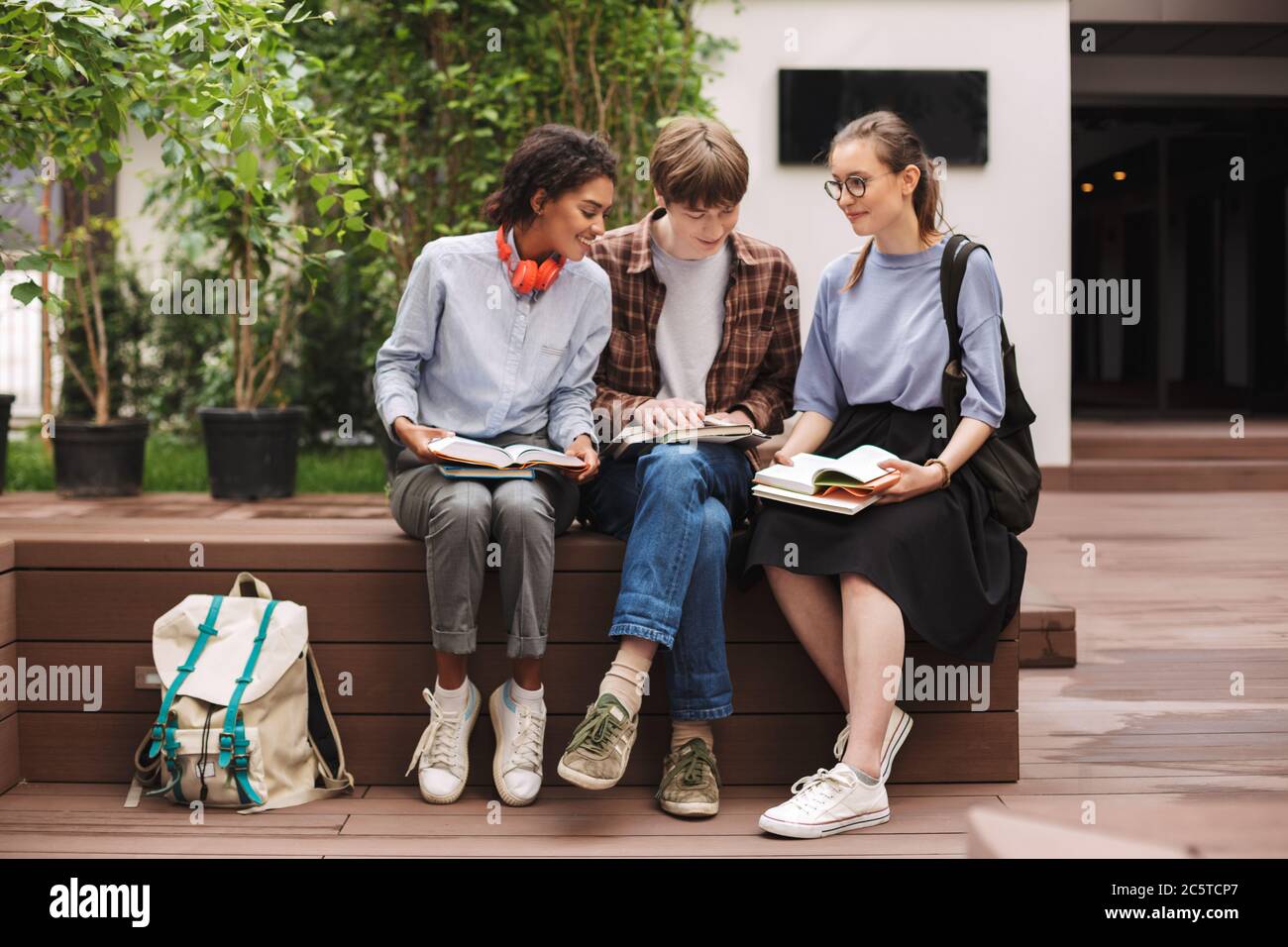 University students smiling on bench hi-res stock photography and ...