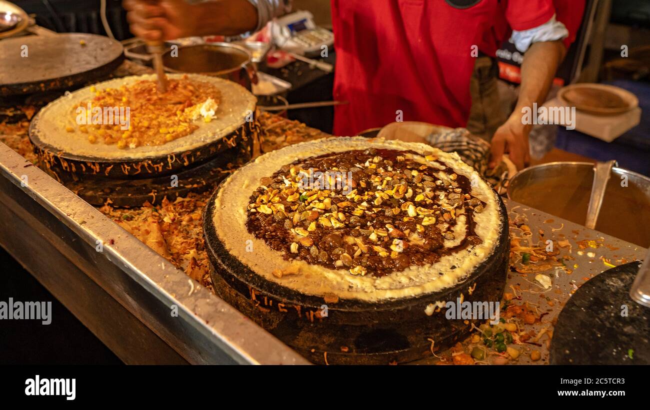 Varieties of dosa cooked in a counter at a food festival Stock Photo ...