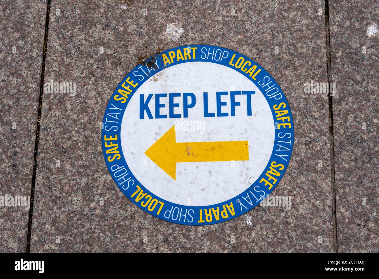 Floor sticker sign asking pedestrians to keep left as part of a one way ...