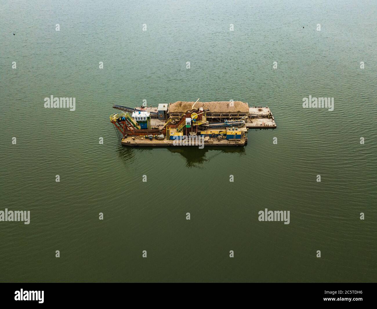 Industrial machine extracting sand from the lake Stock Photo - Alamy