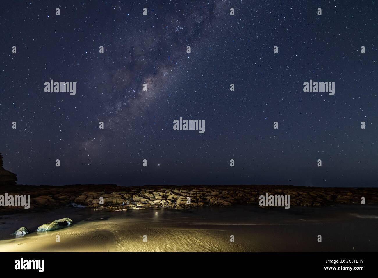 Stars and the Milky Way Night Sky with Rock Platform and Headland taken ...