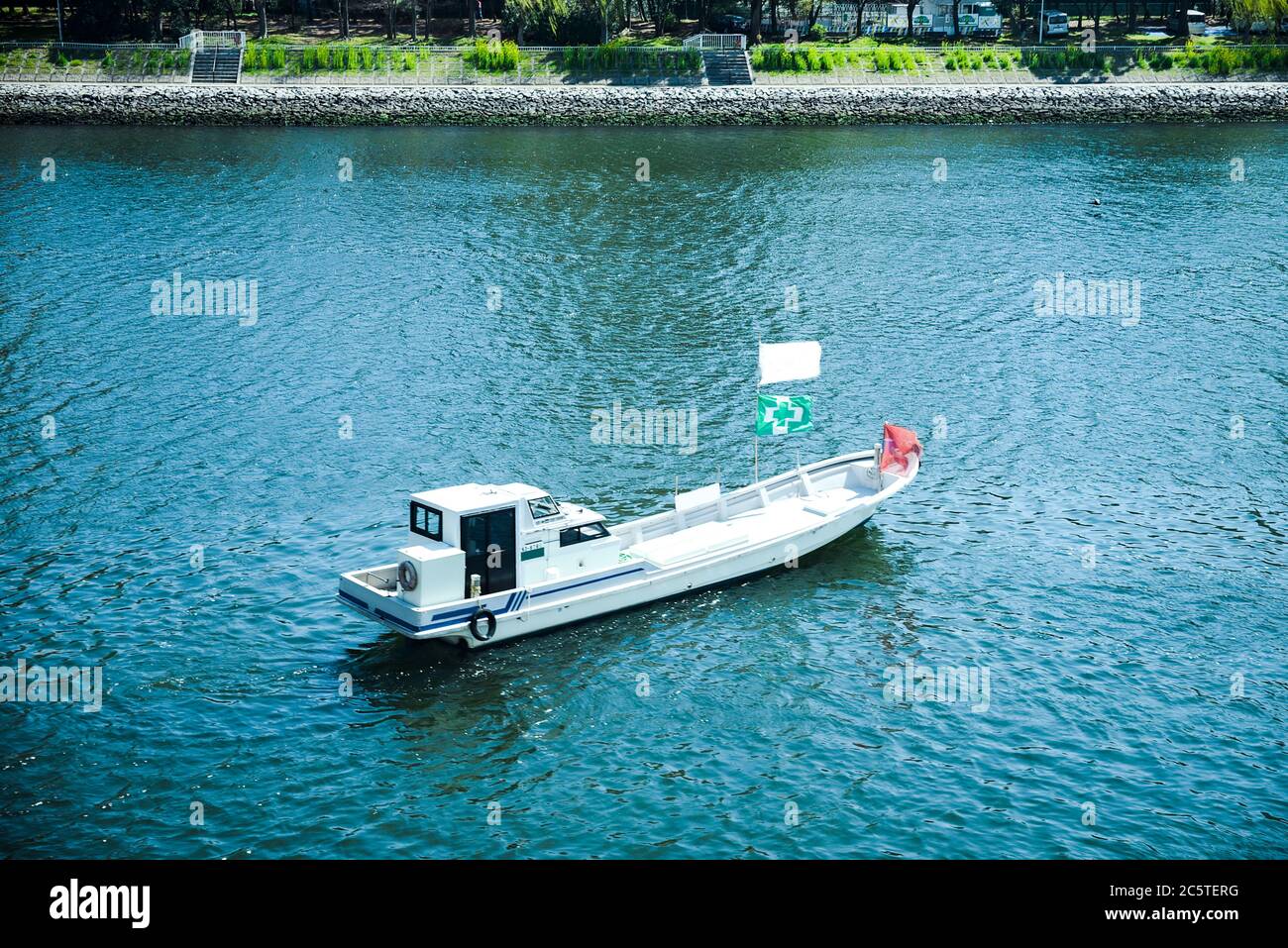 a small white boat floating on a river in Tokyo Stock Photo - Alamy