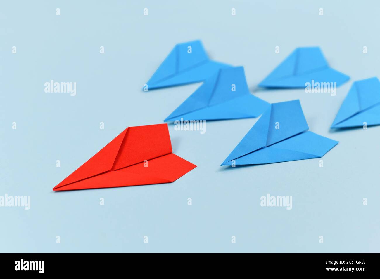 Red paper airplane leading blue airplanes. Concept for discovery and ...