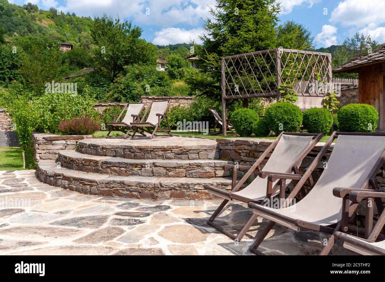 Retro deck chairs or deckchairs with stone slabs or paving flags ...