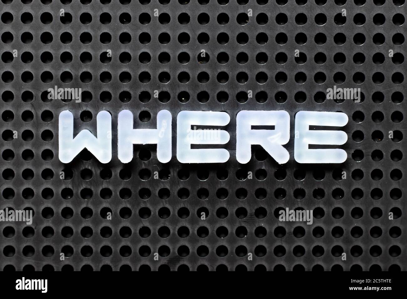 White color alphabet with word where on black pegboard background Stock ...