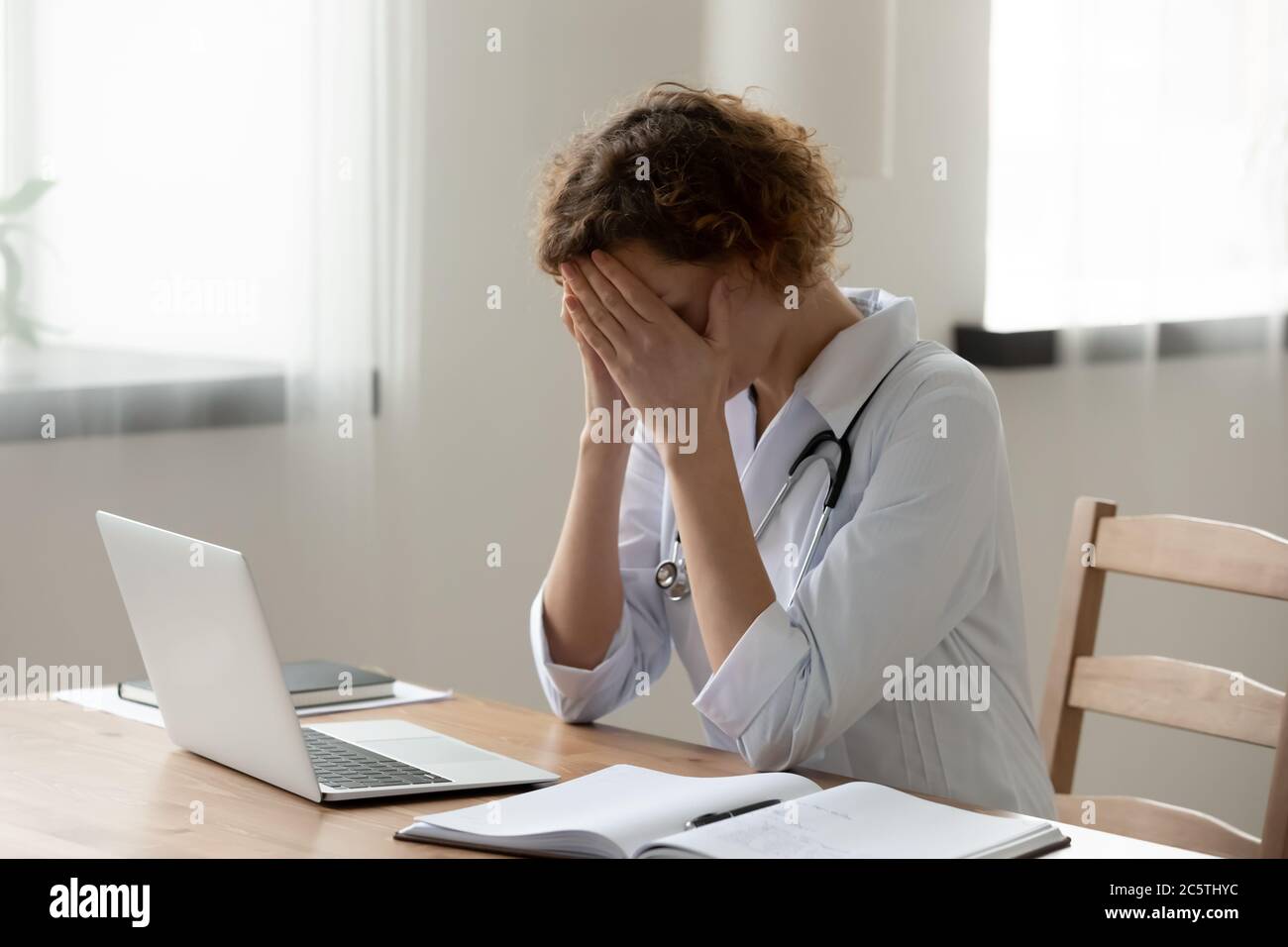 Tired female doctor stressed at workplace in hospital Stock Photo - Alamy