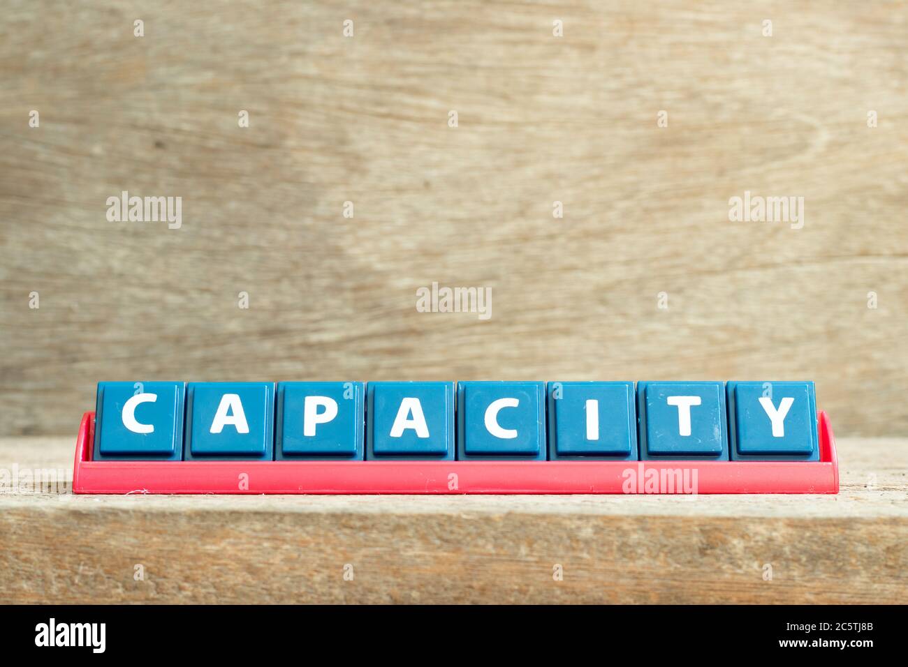 Tile letter on red rack in word capacity on wood background Stock Photo ...