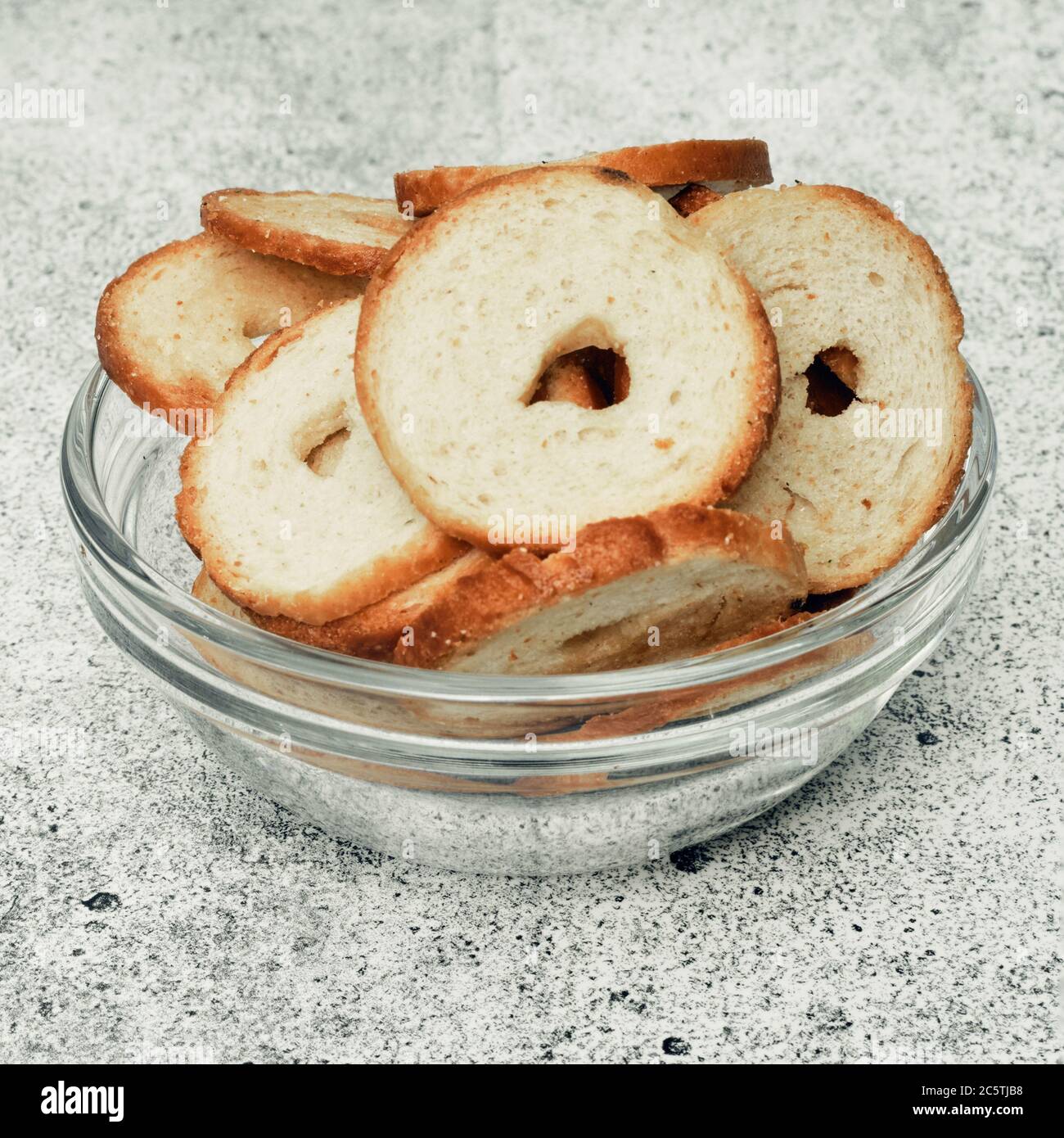 Round crackers of white bread in a glass bowl, snack Stock Photo - Alamy
