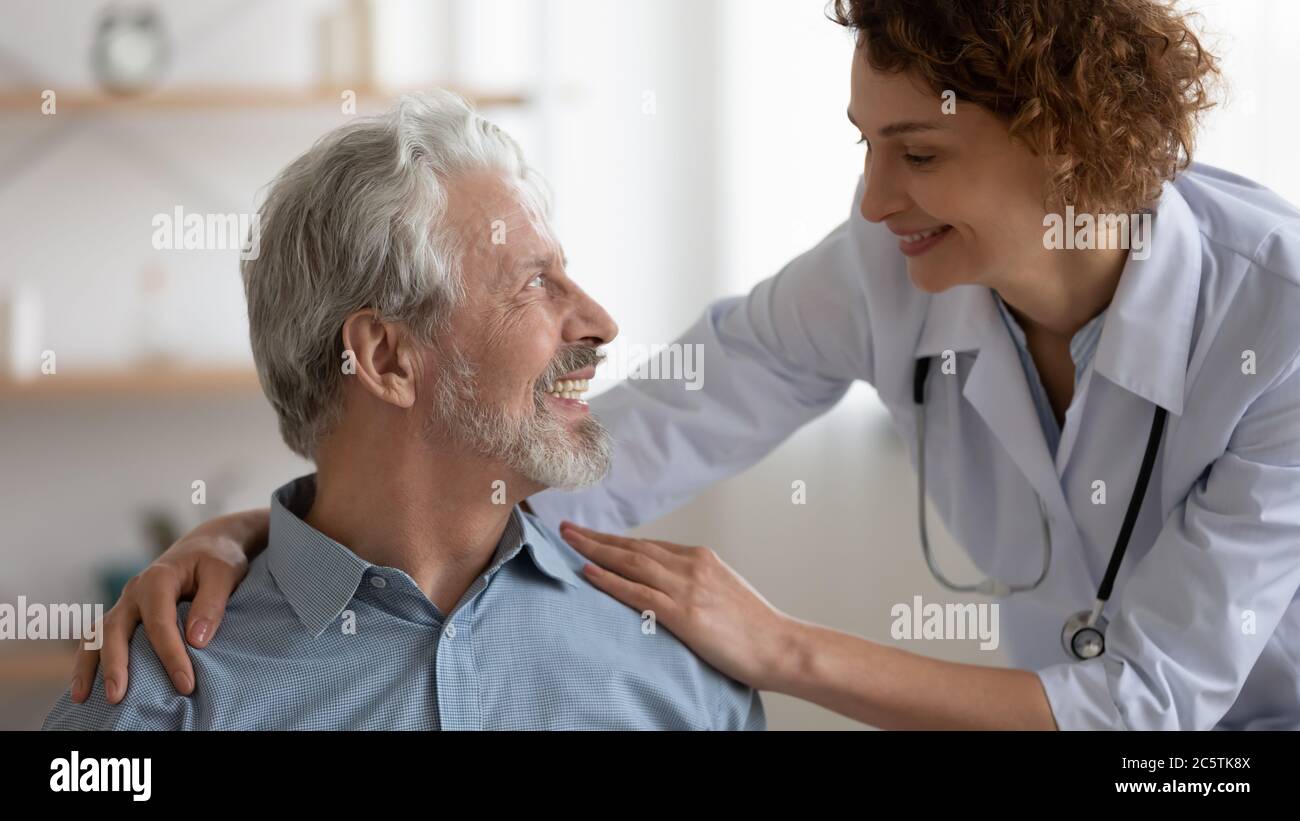 Smiling caring female nurse support senior patient Stock Photo - Alamy