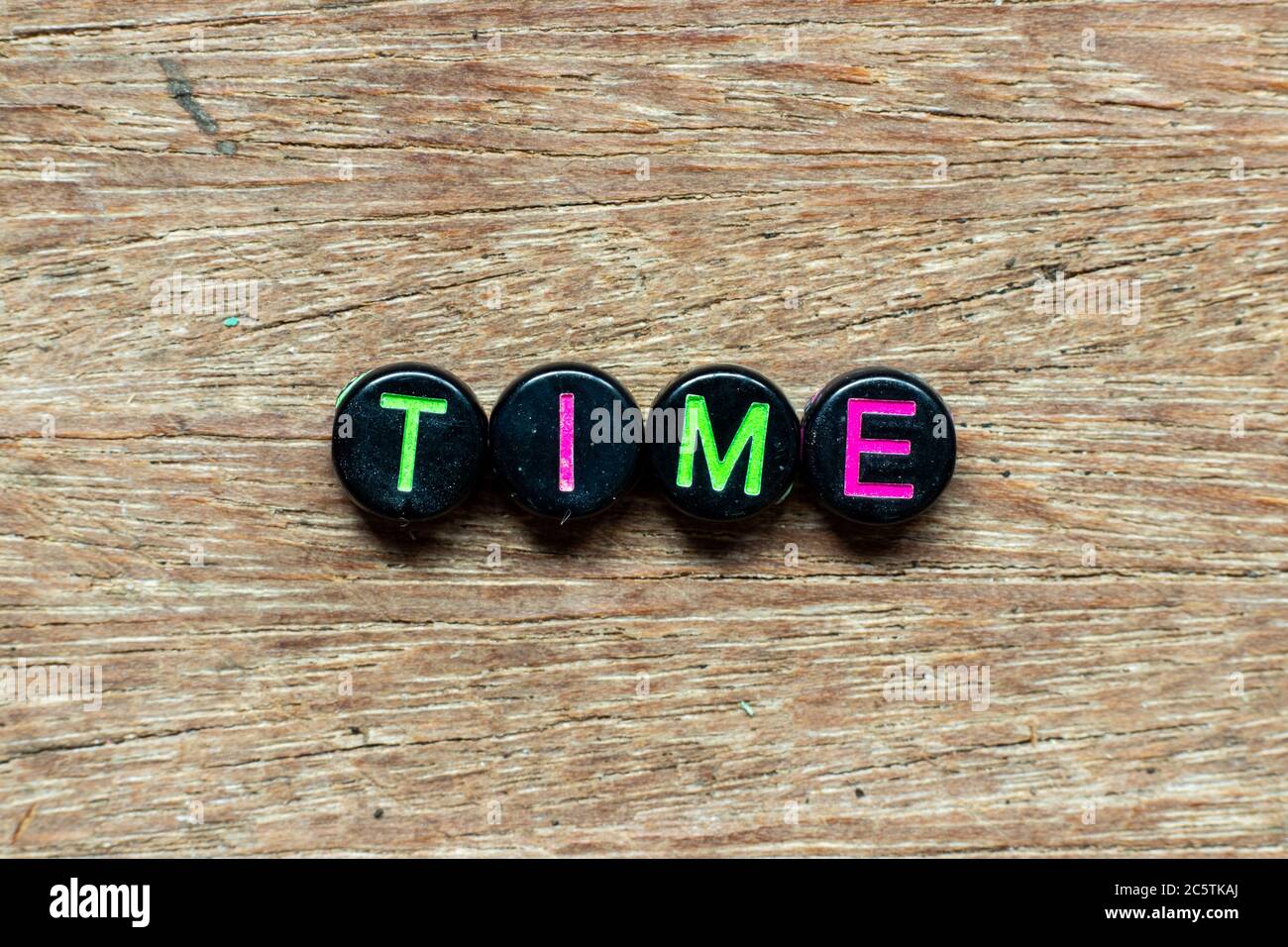 Black bead with color letter in word time on wood background Stock ...