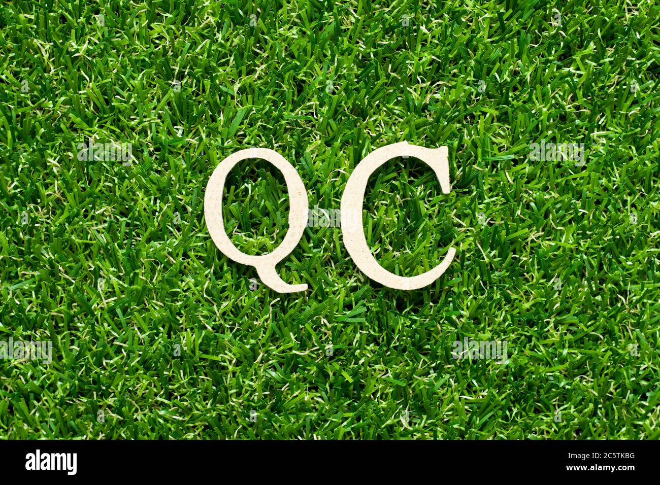 Wood alphabet letter in word QC (Abbreviation of Quality Control) on ...