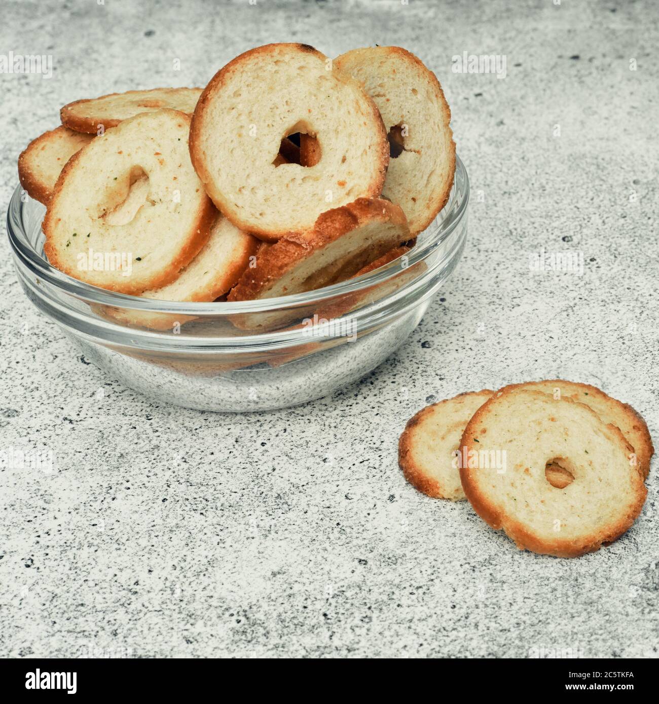 Round crackers of white bread in a glass bowl, snack Stock Photo - Alamy