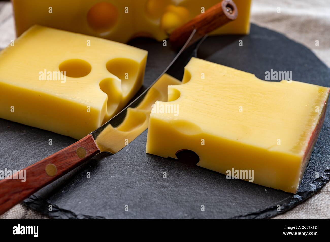 Block of Swiss medium-hard yellow cheese emmental or emmentaler with ...