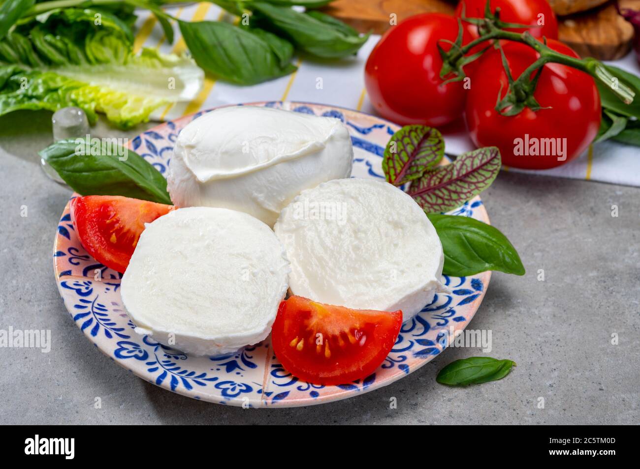 Making of fresh caprese salad with soft Italian cheese from Campania ...