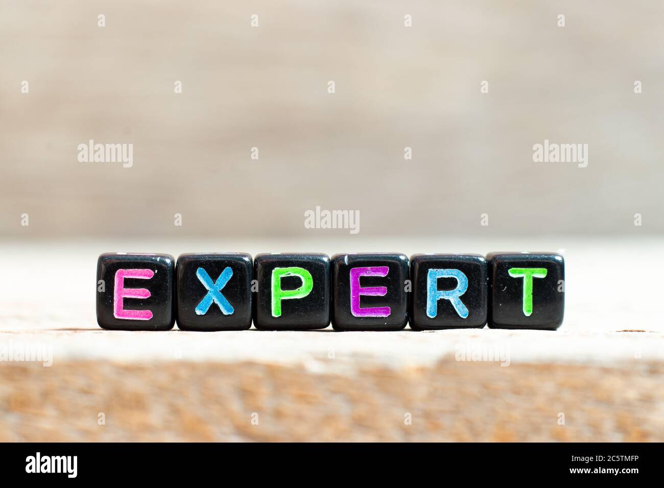 Black bead with color letter in word expert on wood background Stock ...