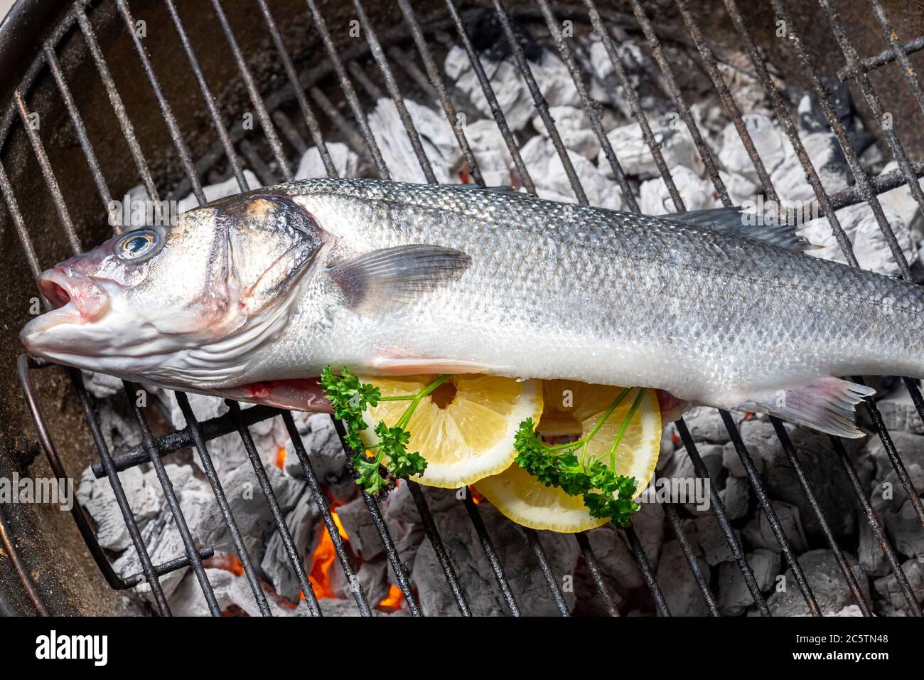 bass with lemon on the bbq Stock Photo - Alamy