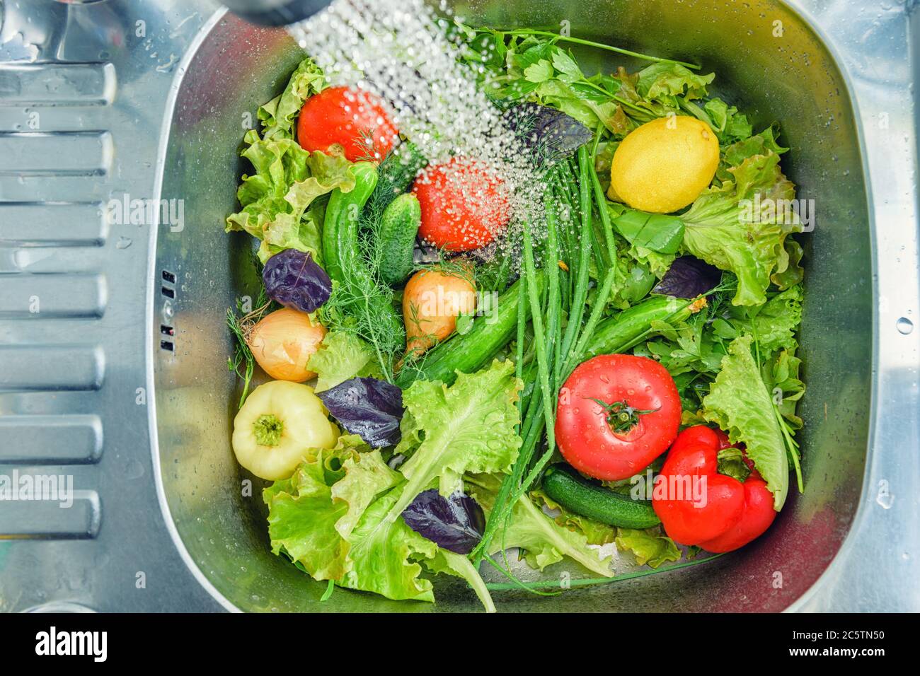 Wash vegetables before eating, very good for health. A group of ...