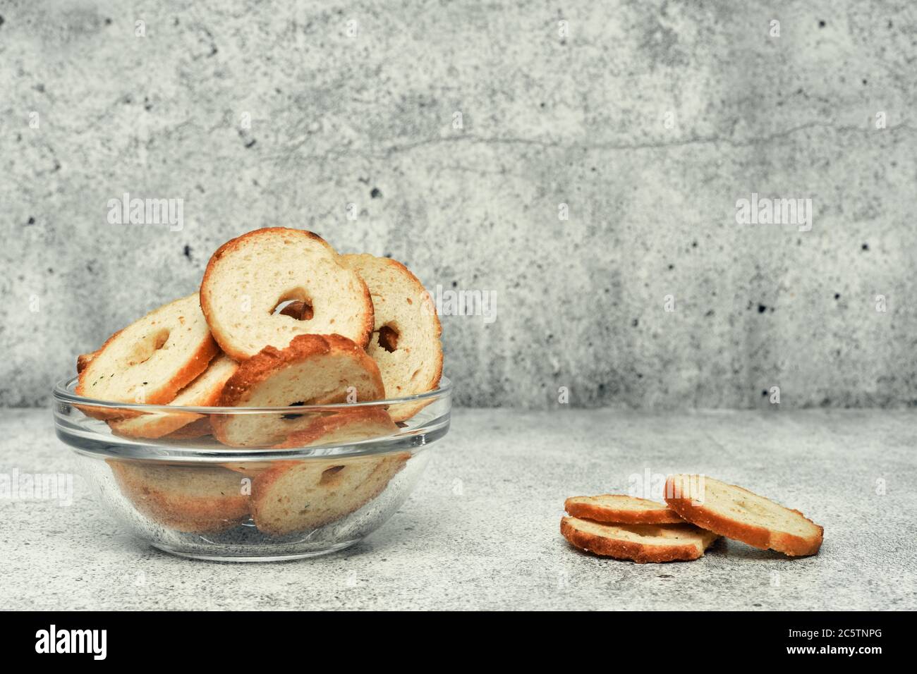 Round crackers of white bread in a glass bowl, snack Stock Photo - Alamy