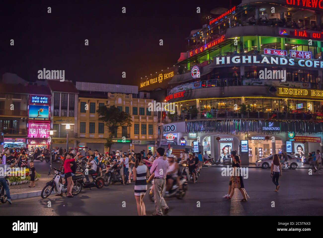 Street scene at night of people gathering at Dong Kinh Nghia Thuc ...