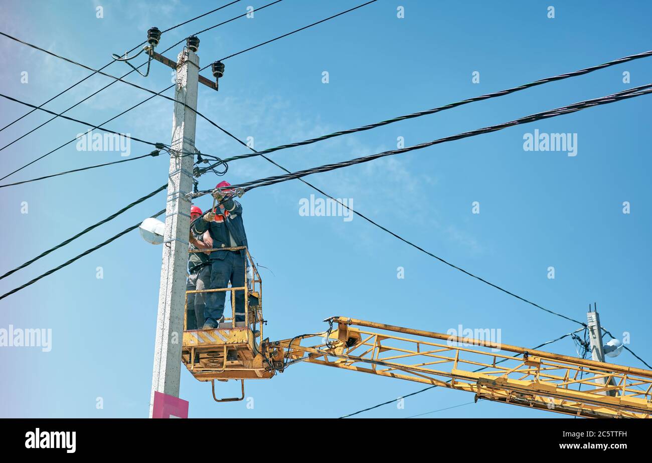 electricians work on a pole Stock Photo - Alamy