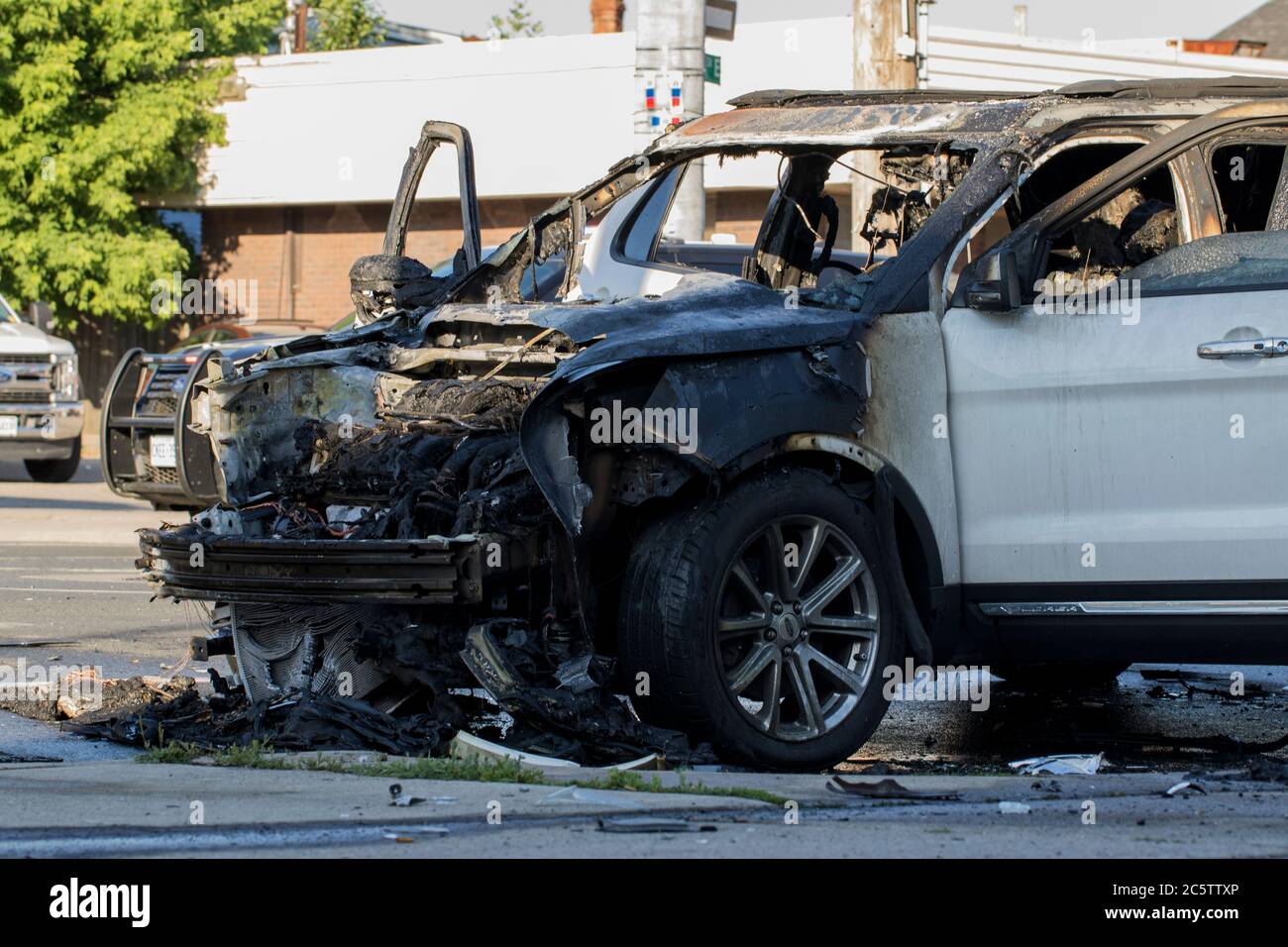 Totaled car charred car fire close up after being extinguished by fire ...