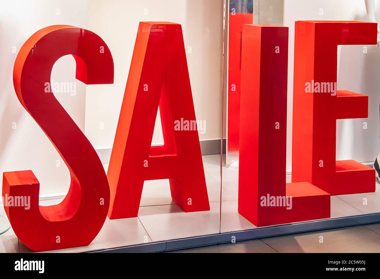 Big red banner for sale in a shopping center. The beginning of sales in ...