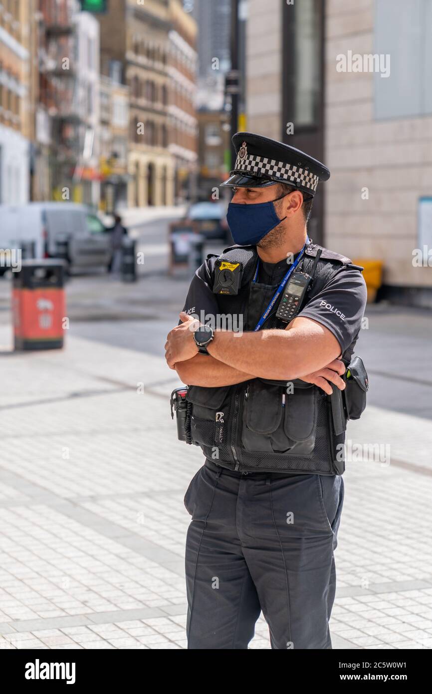 LONDON, ENGLAND - JULY 3, 2020: Male Police Officer on duty outside ...