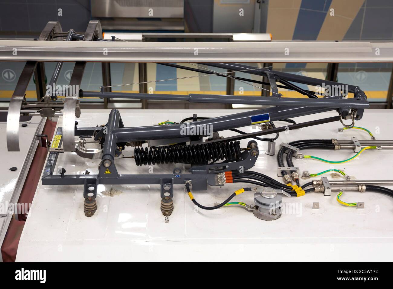 Subway train electric overhead lines on a train station during a ...
